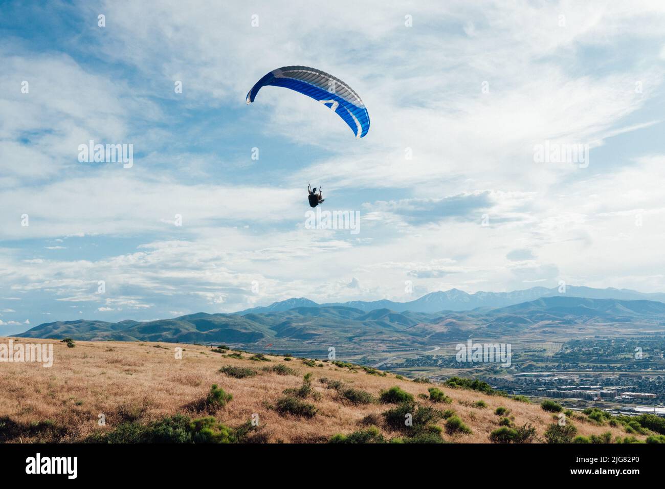 A paraglider flying near the Point of the Mountain in Salt Lake City ...