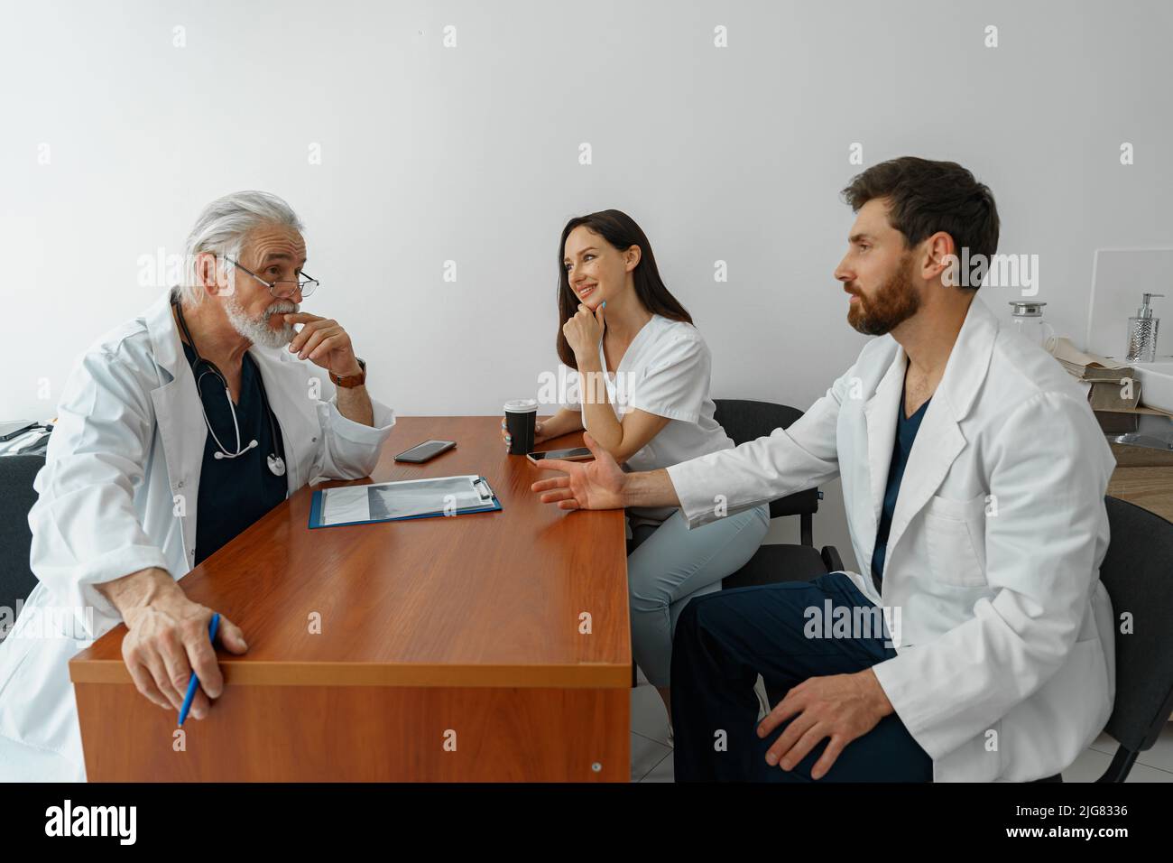 Successful medical doctors are discussing diagnosis during the ...