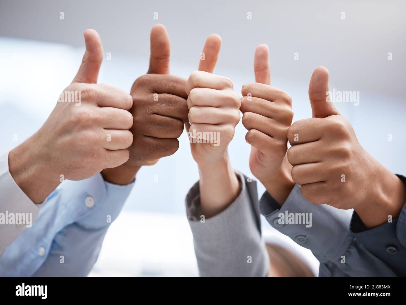 Its a yes from all of us. Shot of a group of business people giving the ...