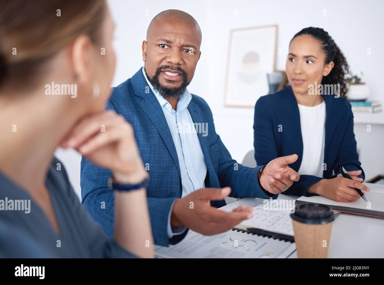 Diverse group of business people talking in a meeting and using ...