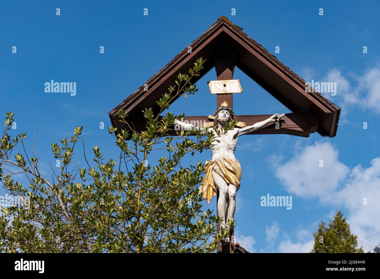 A beautiful shot of carved figure of Jesus Christ on the wooden cross ...