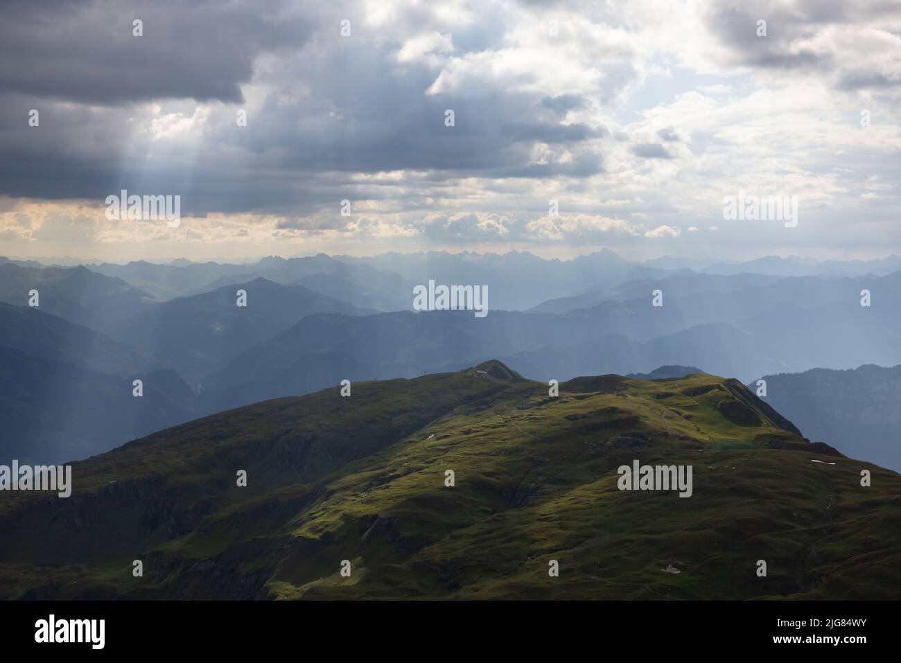A stunning view of sun rays falling on mountains on a cloudy day Stock ...