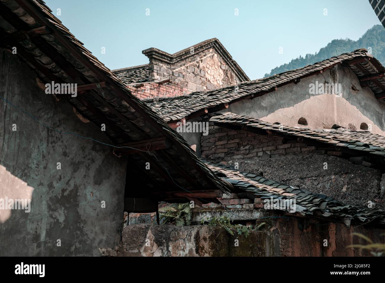 An abandoned house rooves and a blue sky Stock Photo - Alamy