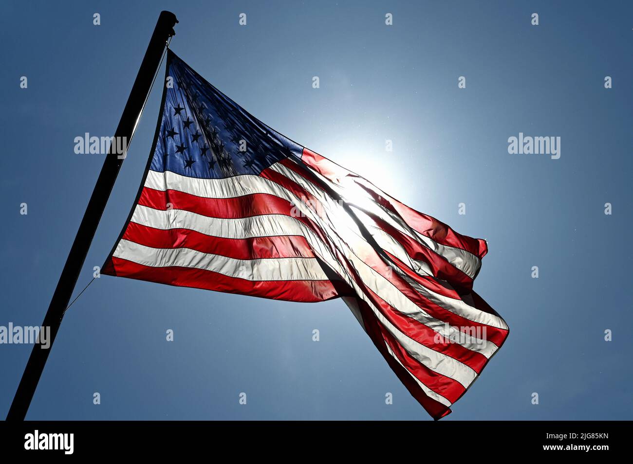 American flag in front of the sun; Washington DC, United States of ...