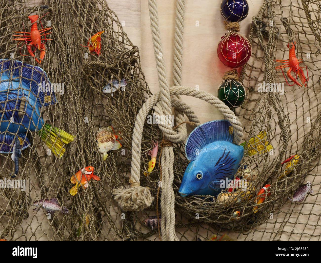 A beach art made from old fishing net and sea animal toys Stock Photo ...
