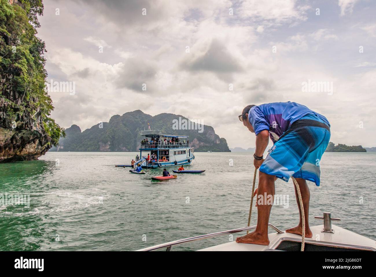 The man on the boat pulling the rope. Phuket, Andaman Sea, Thailand ...