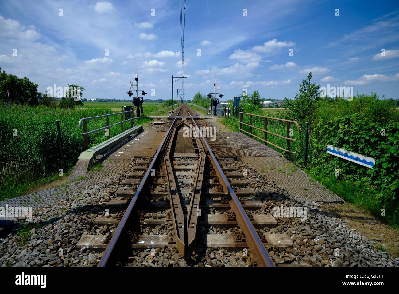 railroad crossing between the meadows in the Netherlands Stock Photo ...