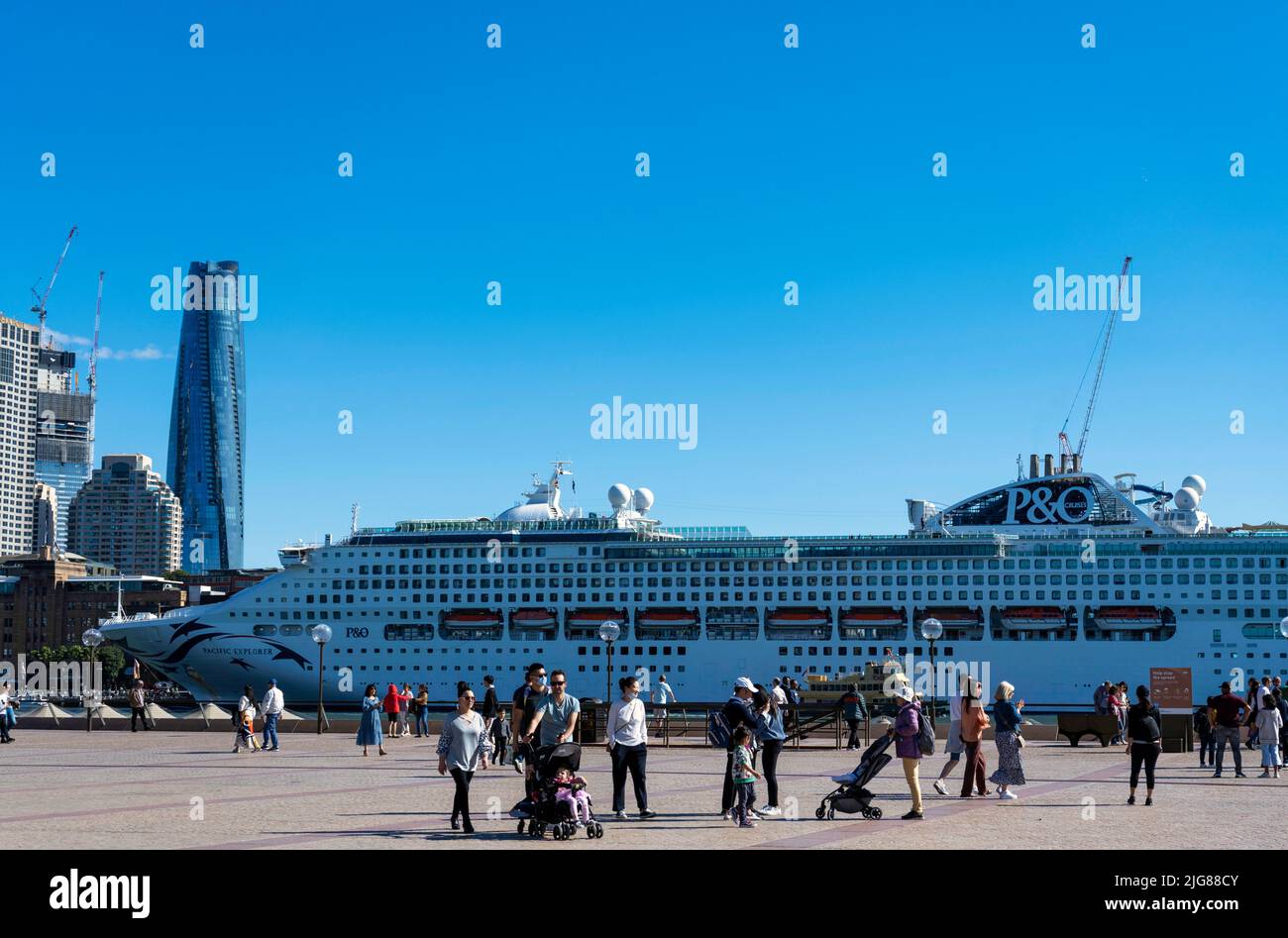 A crowd walking near a cruise ship parked at Circular Quay Stock Photo ...