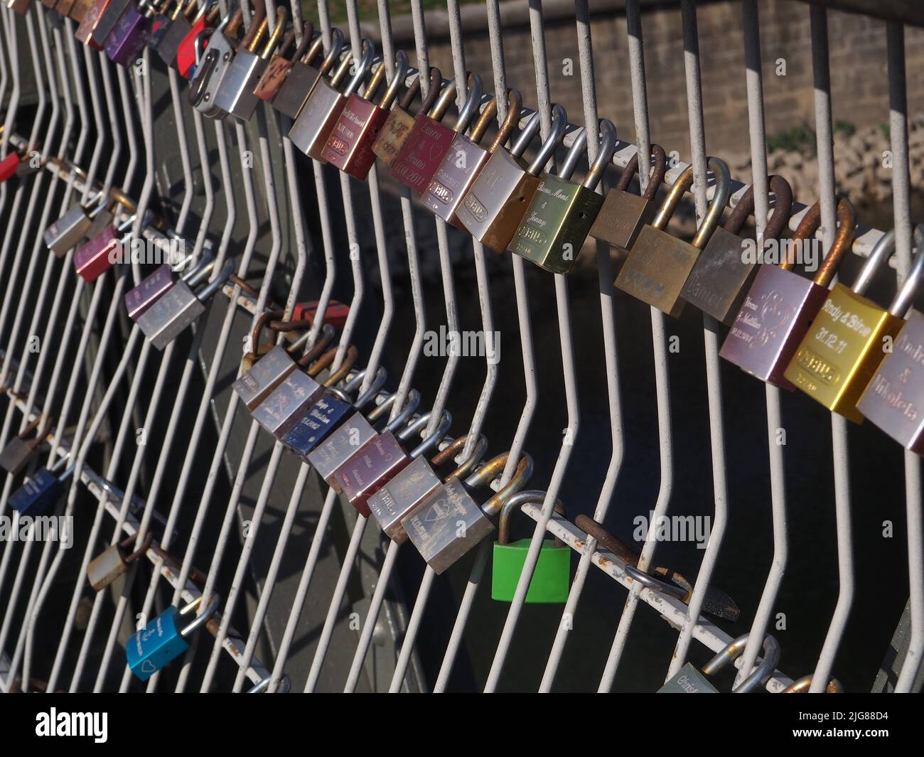 The locks with the names of spouses on it hanging on a bridge as a sign ...