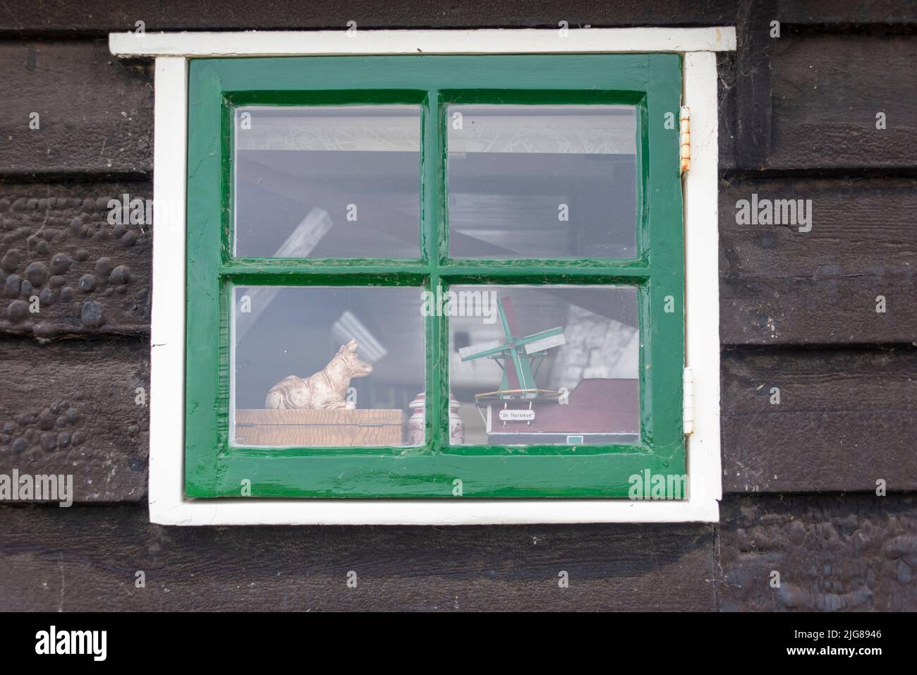 Miniature of a windmill, Dutch windmill, old wooden window, close-up ...