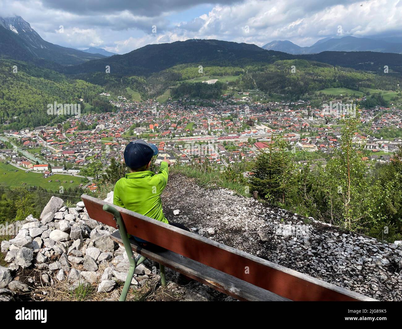 Boy looking at Mittenwald from bench, Mittenwalder Hütte, nature ...