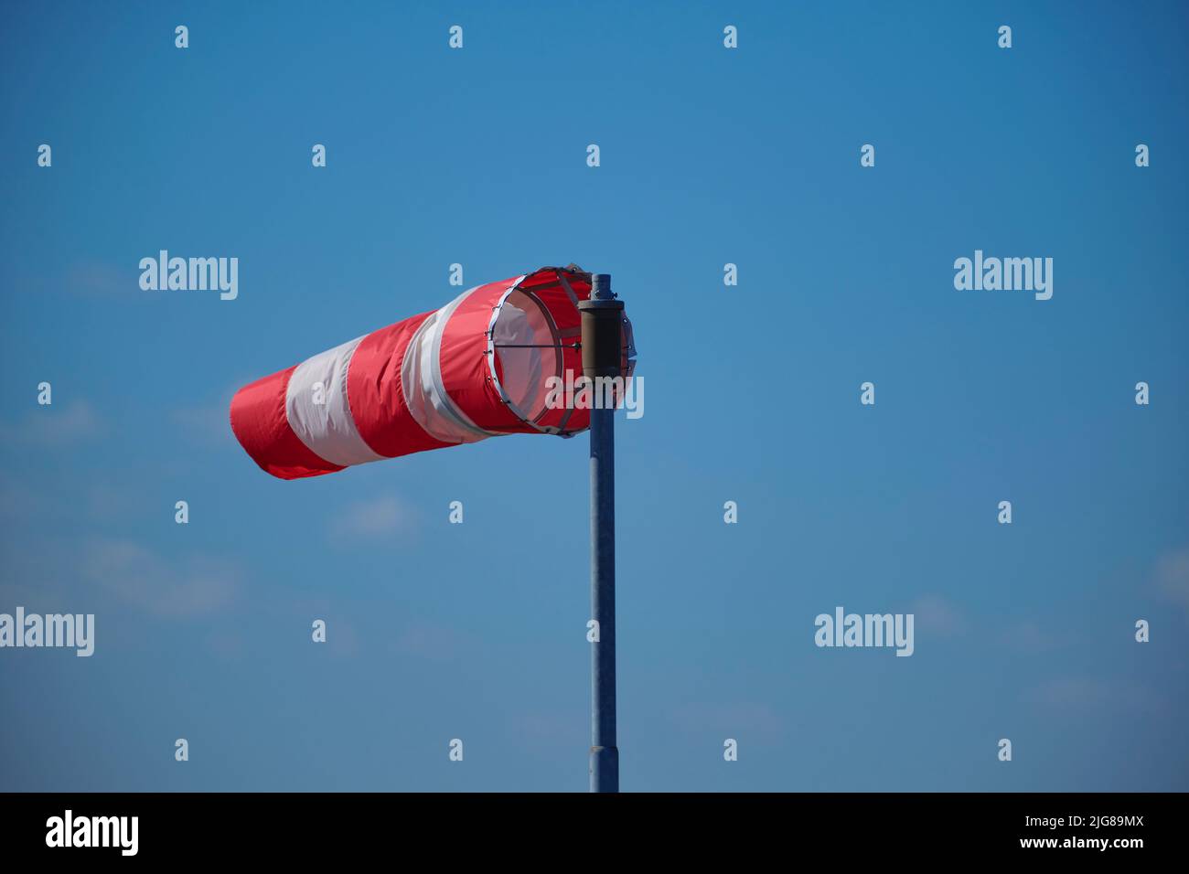 Windsock indicator of wind on runway airport Stock Photo - Alamy