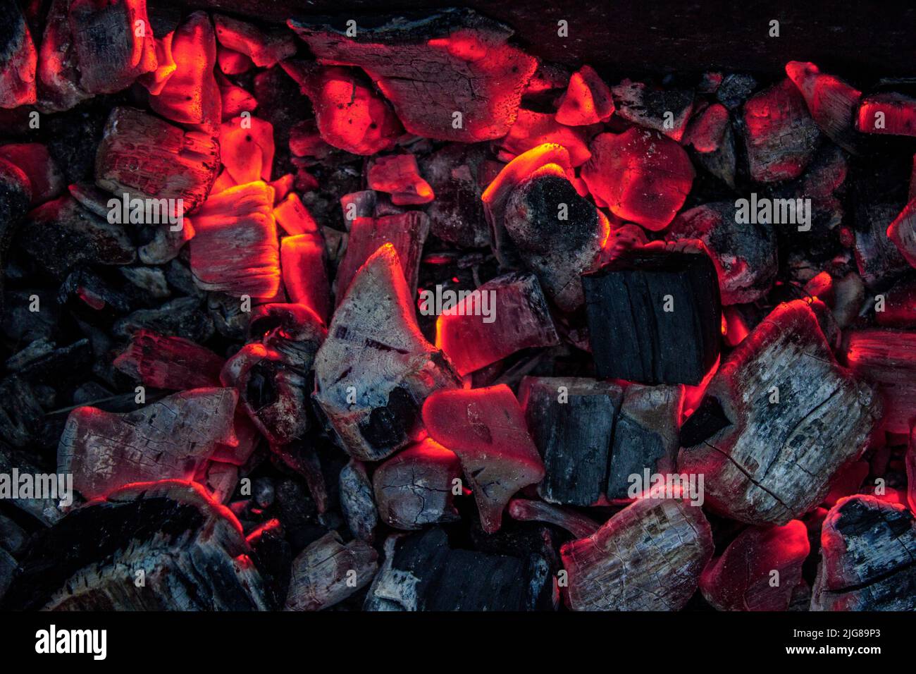 Pieces of burning coal glowing in the dark Stock Photo - Alamy