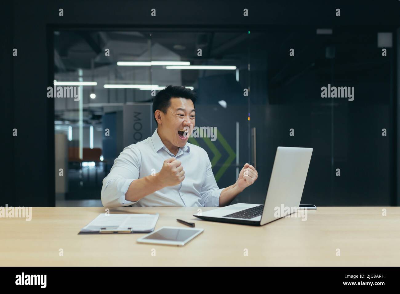 Overjoyed businessman celebrating success and victory, holding hands up ...