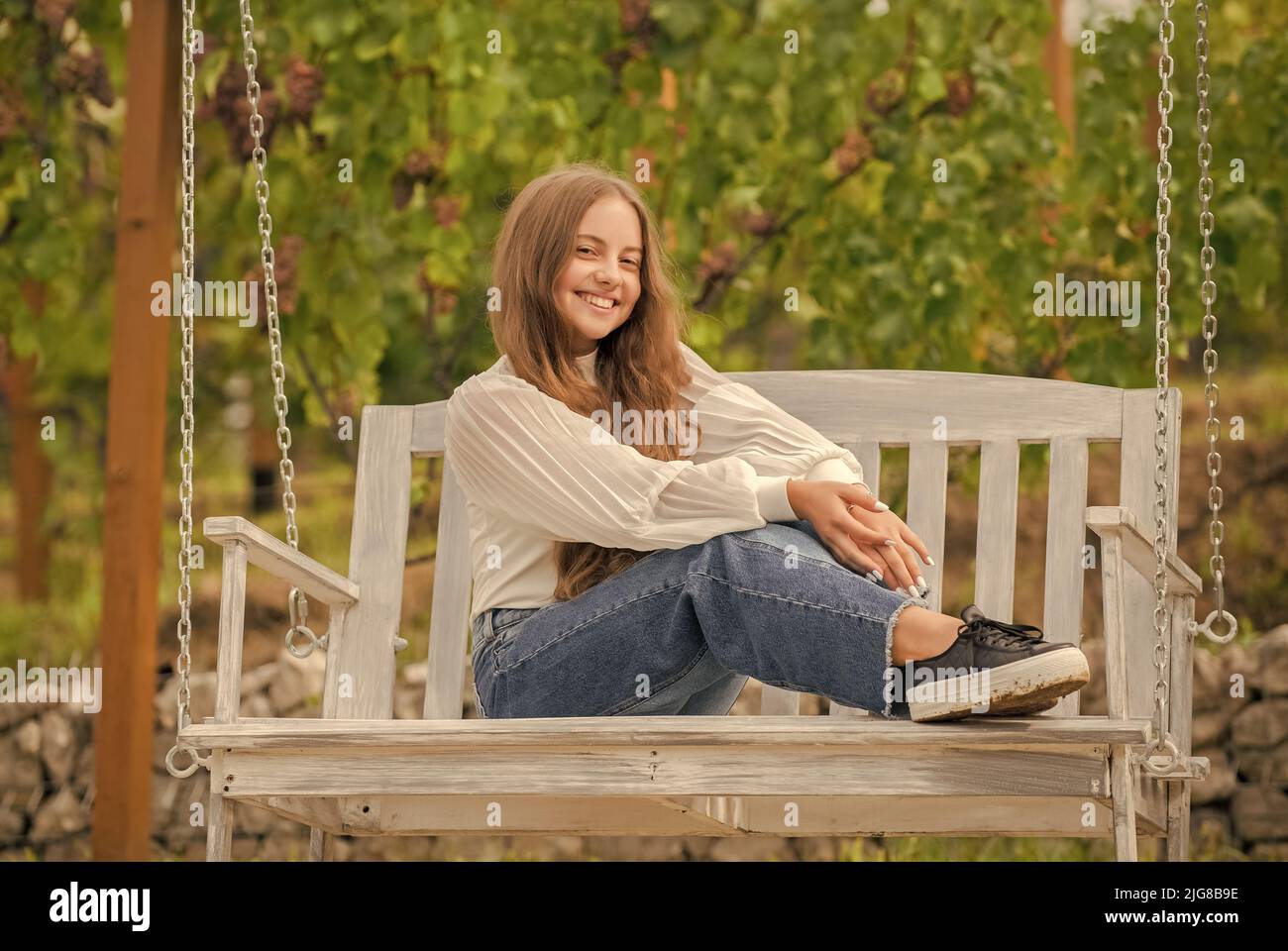 smiling child sit on swing outdoor, playground Stock Photo - Alamy