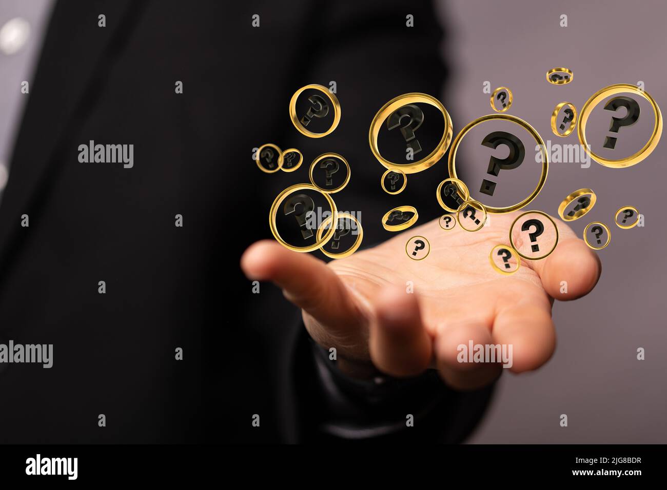 A closeup of a hand holding question marks signs icons Stock Photo - Alamy