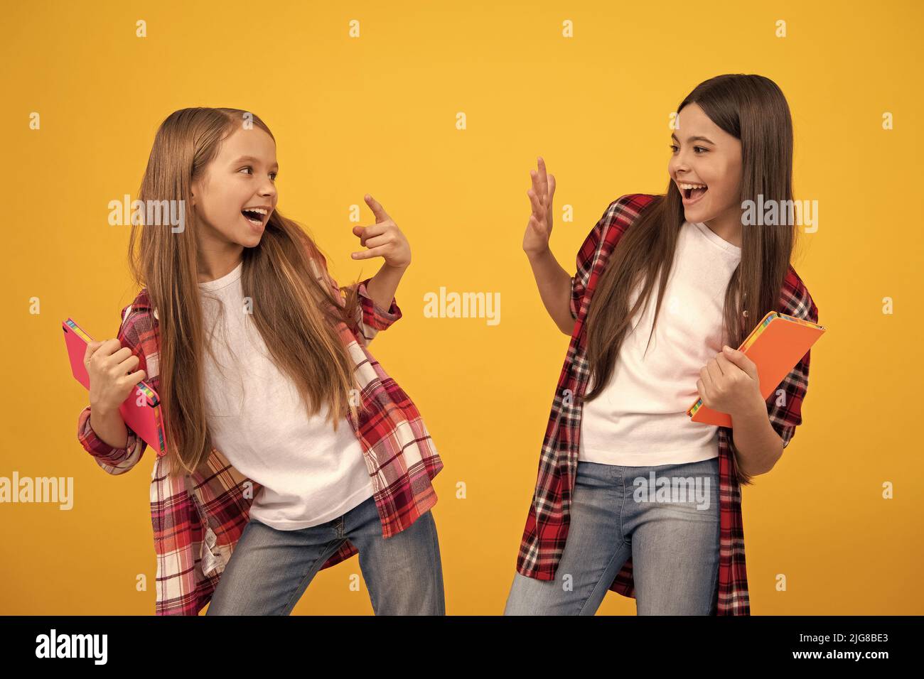 glad happy children in casual checkered shirt with copybooks, fun Stock ...