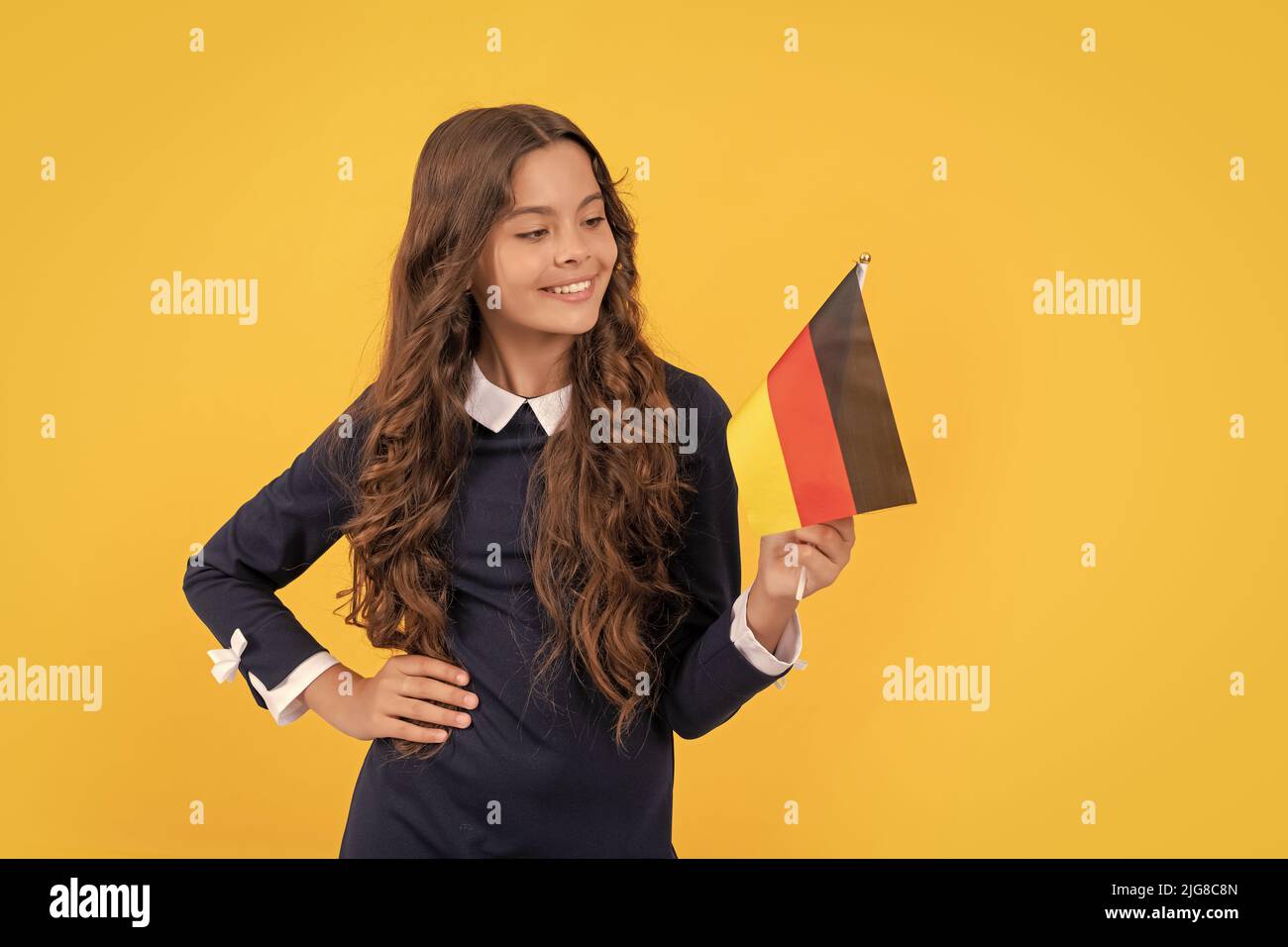 happy child hold german flag yellow background, patriotism Stock Photo ...