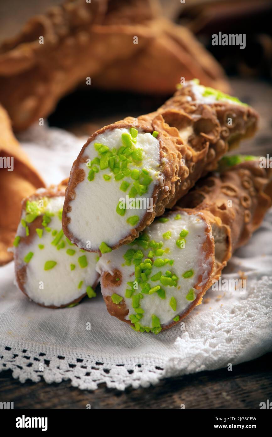 Freshly baked sicilian Cannoli dusted with powdered sugar close up ...