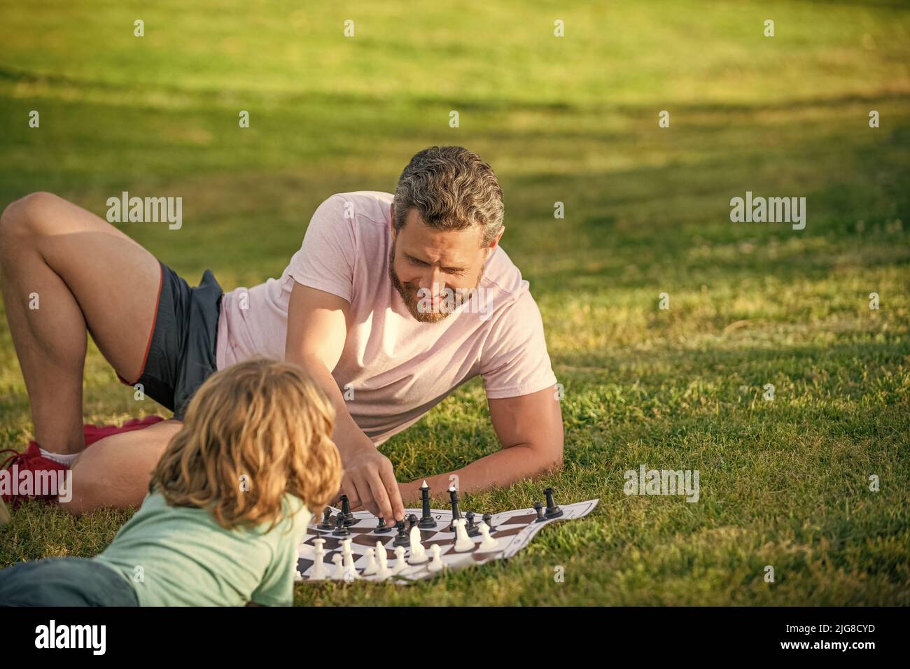 strategic and tactic. tutorship. dad and boy play logic game. father ...