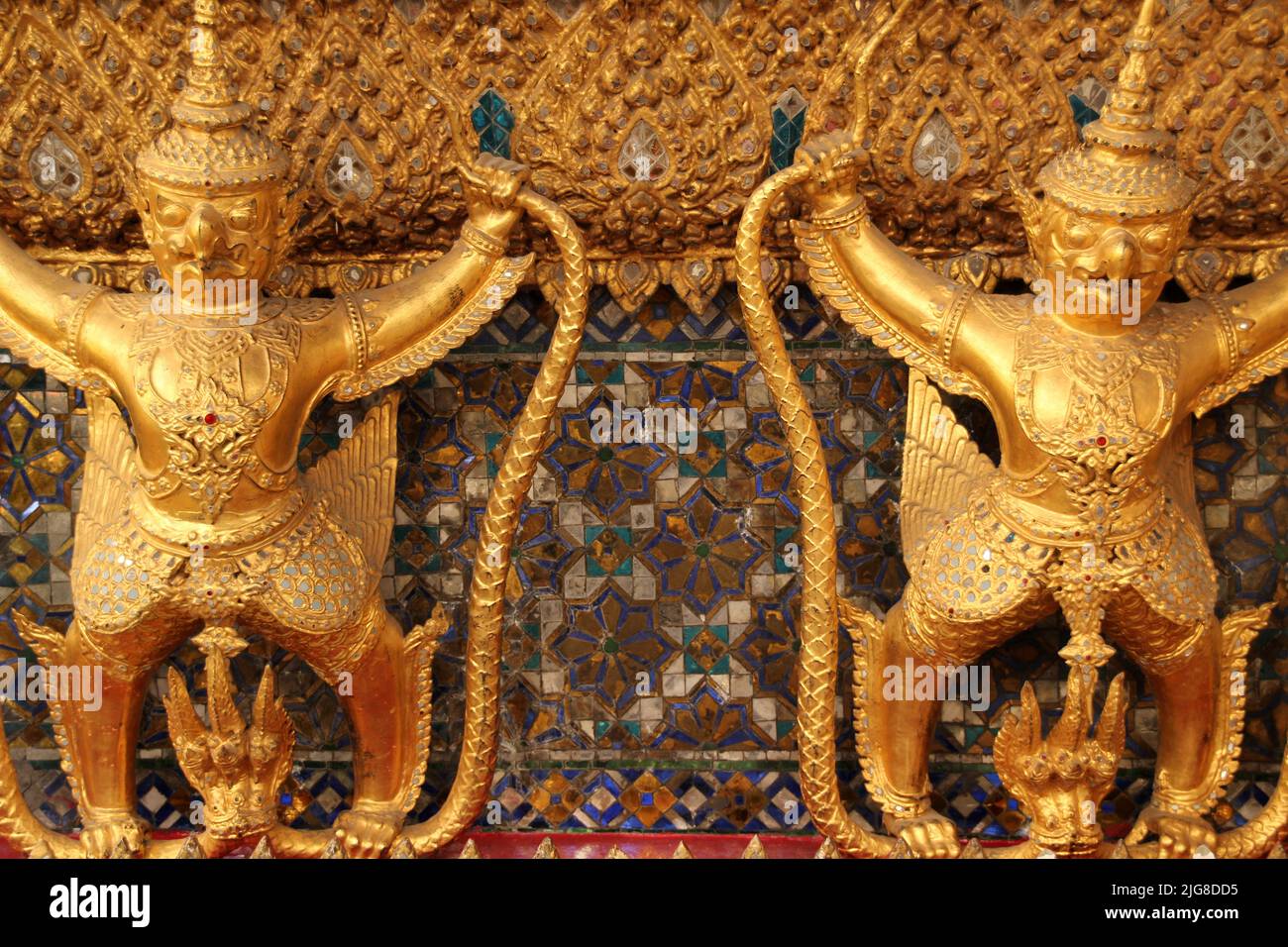 The golden sculptures of Garuda and Naga in the Wat Phra Kaew temple in ...