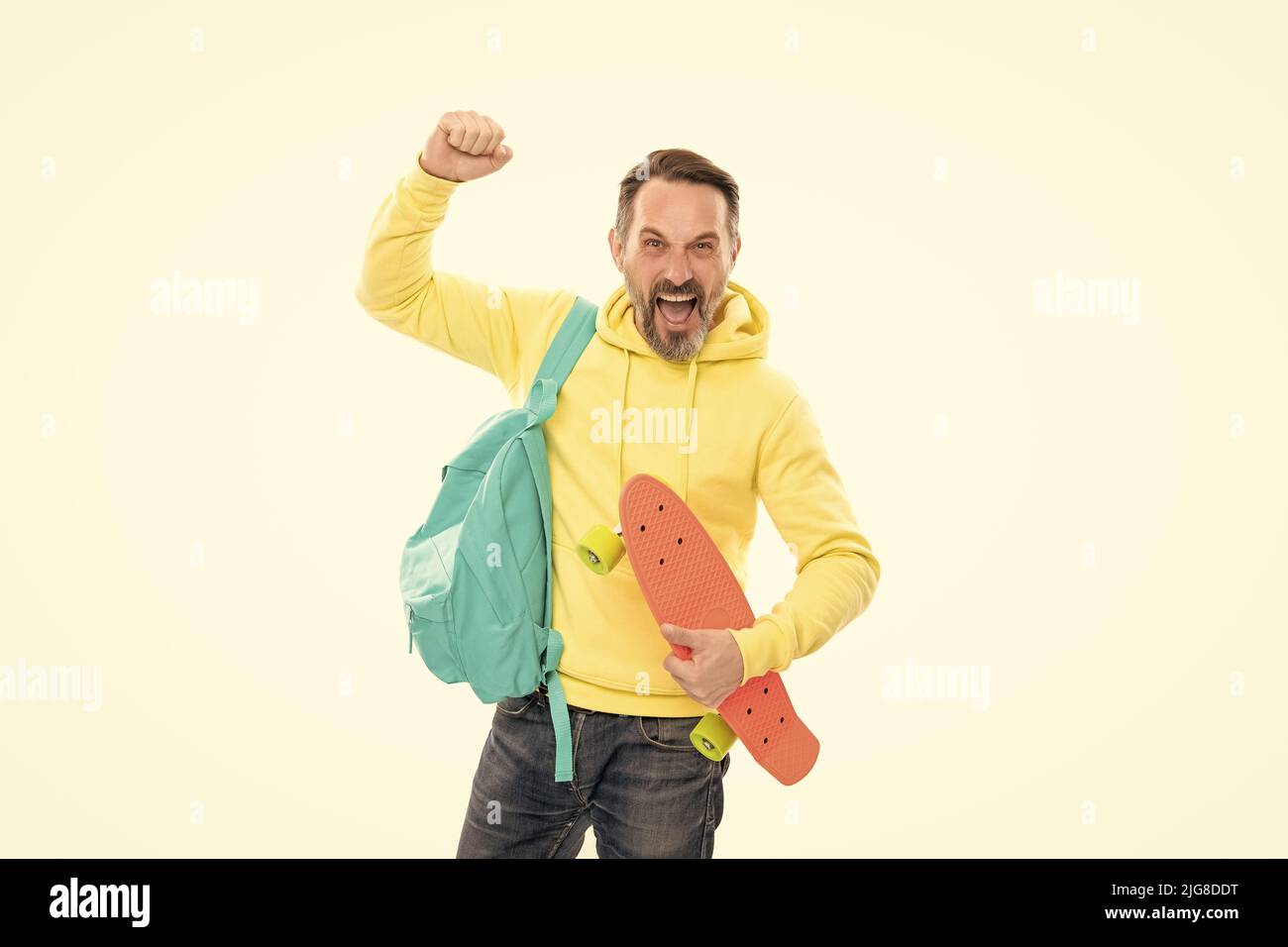 mature happy man carry backpack and penny board. smiling senior guy ...