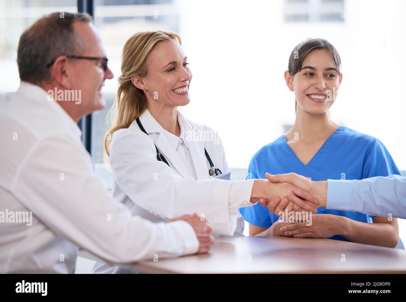Two doctors shaking hands in a hospital hi-res stock photography and ...