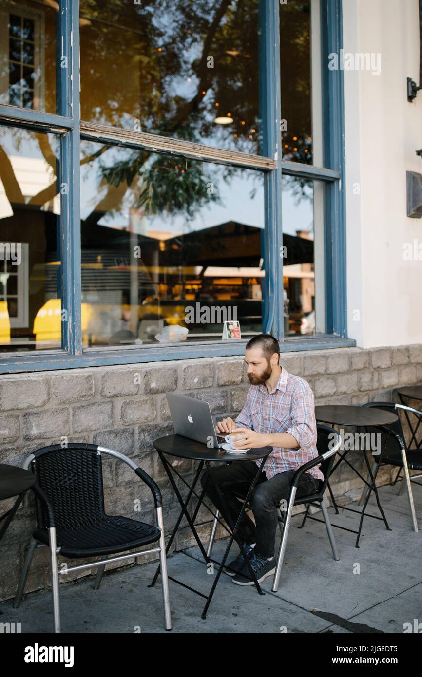 Man working remotely from cafe hi-res stock photography and images - Alamy