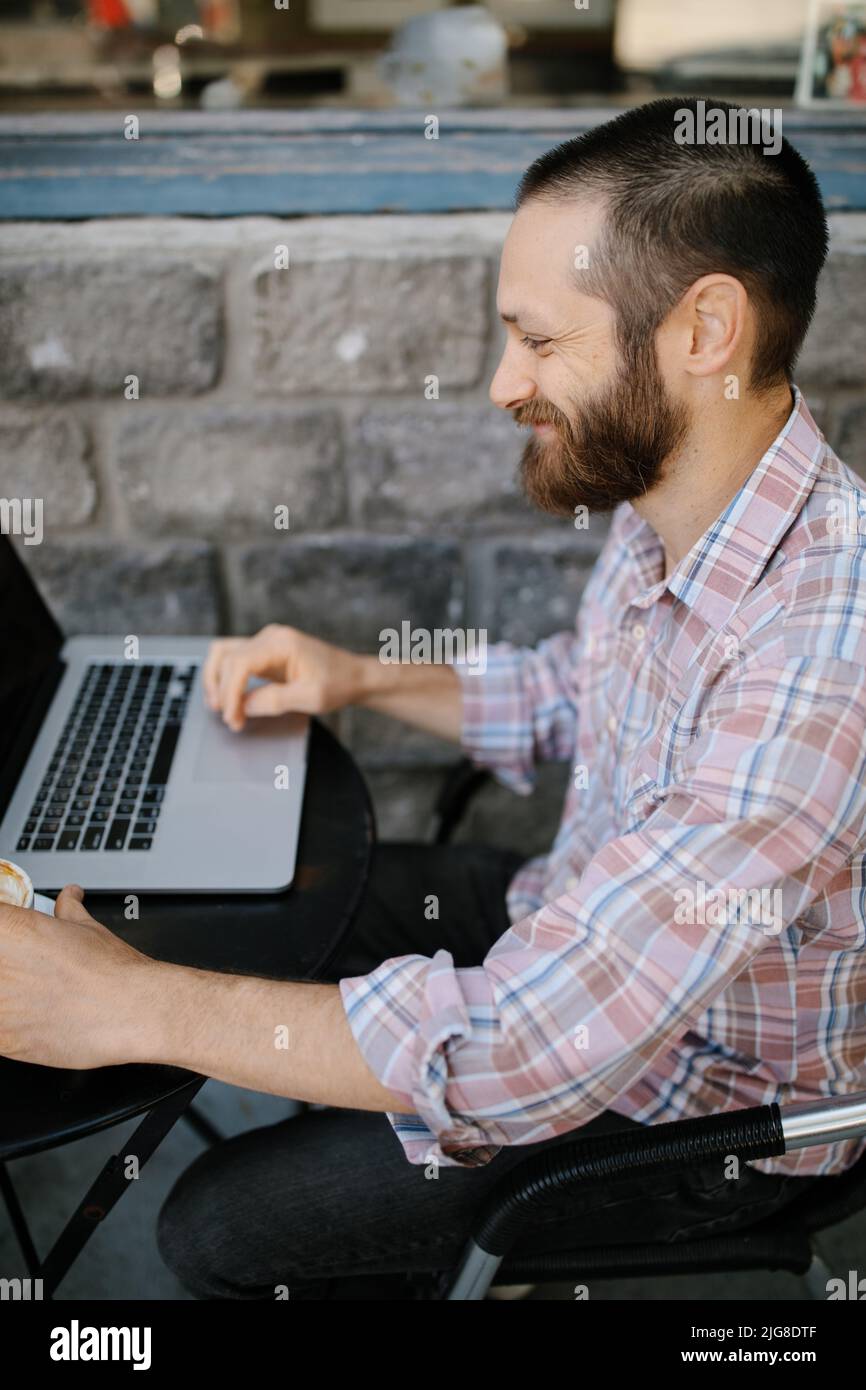 Man working remotely from cafe hi-res stock photography and images - Alamy