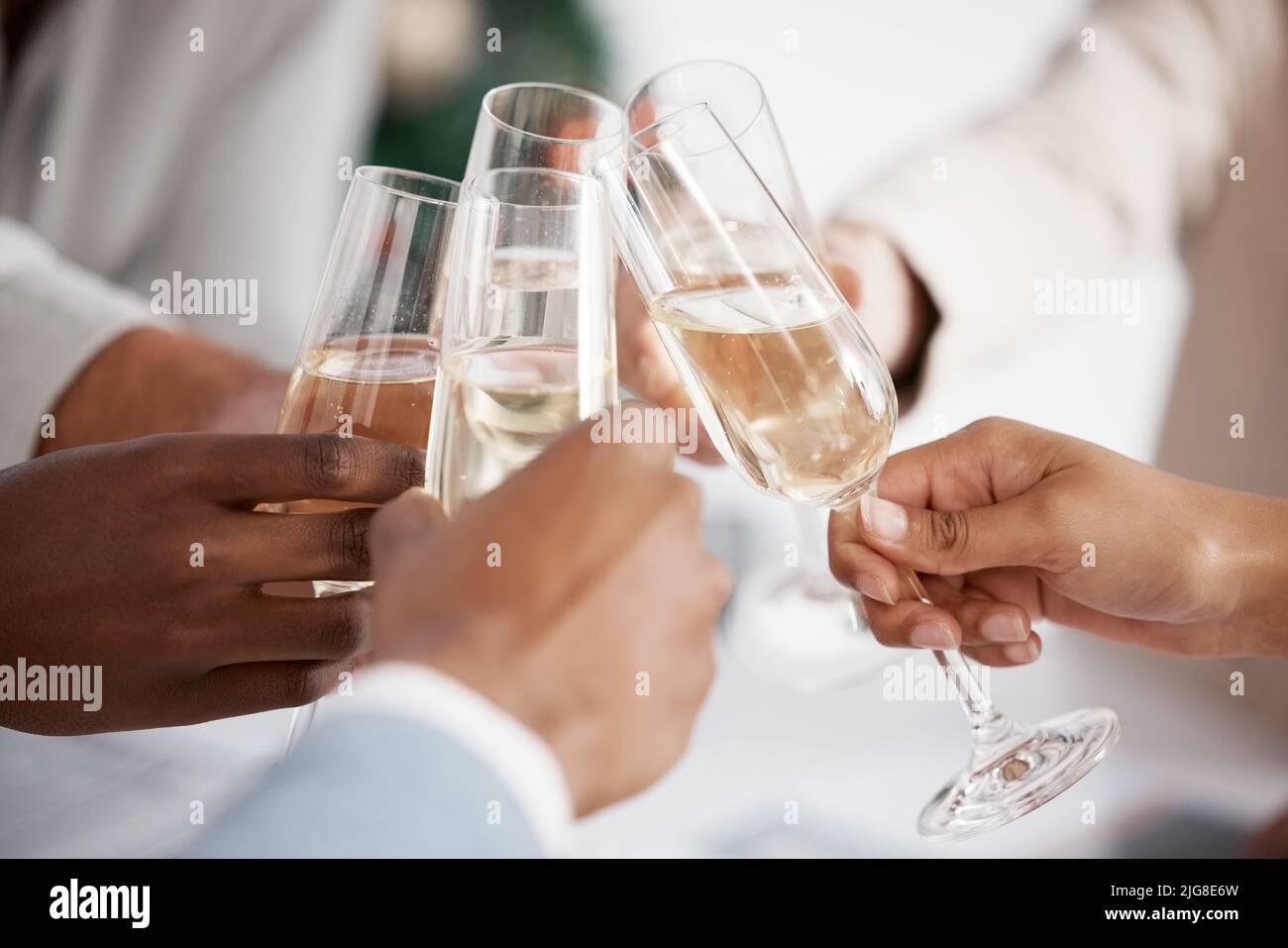 Cheers team. Shot of a group of unrecognizable colleagues having a ...