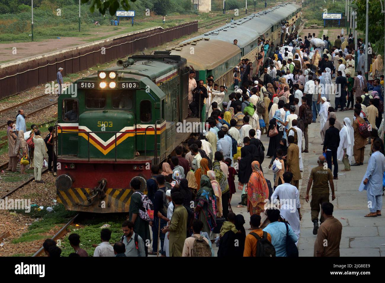 Pakistani people boarding on the roof top of a crowded train as they ...