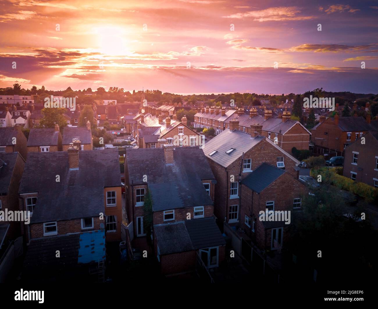 A bird's eye view of Victorian terraced houses at pink sunset in UK ...