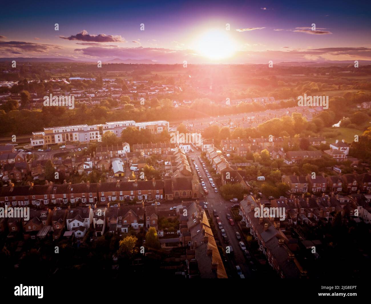 A bird's eye view of Victorian terraced houses at pink sunset in UK ...