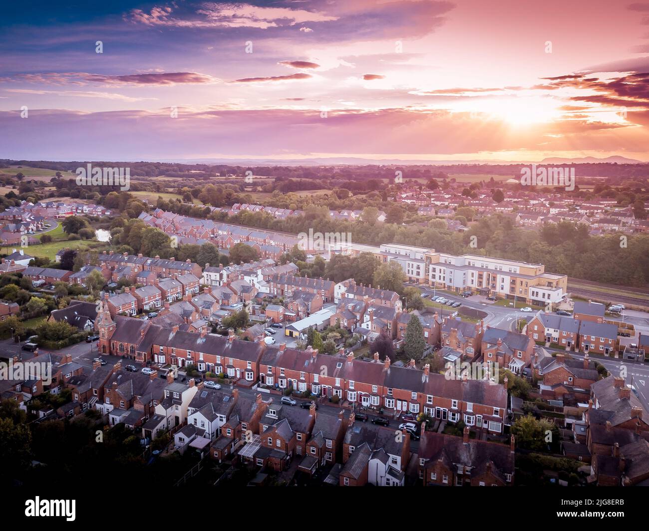 A bird's eye view of Victorian terraced houses at pink sunset in UK ...