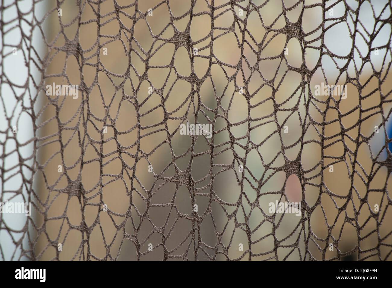 Wicker mesh of threads as background with soft blurred focus as ...