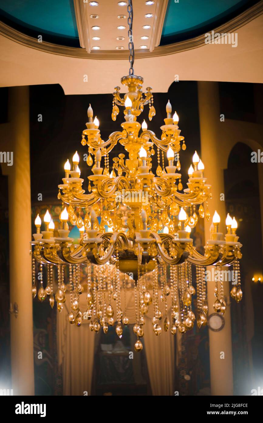 A vertical closeup of an old-fashioned beautiful chandelier hanging on ...