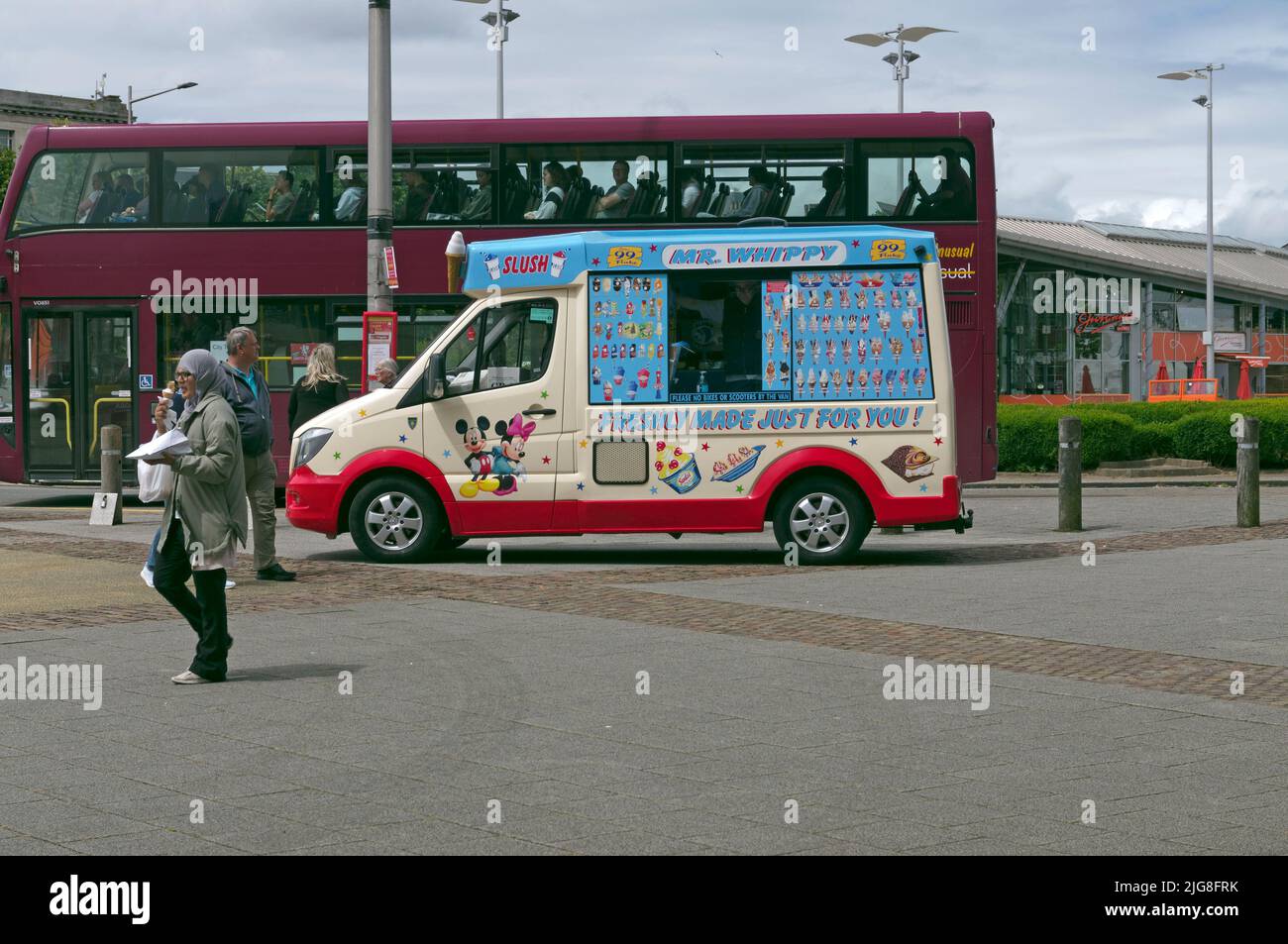 Young Asian woman enjoys an ice cream, Mr Whippy ice cream van at ...