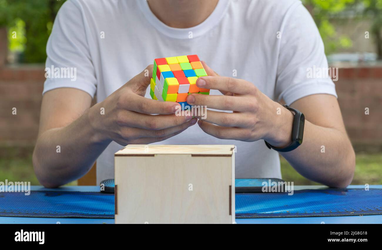 Children's hands hold a mechanical logic puzzle toy. Ready for a tough ...