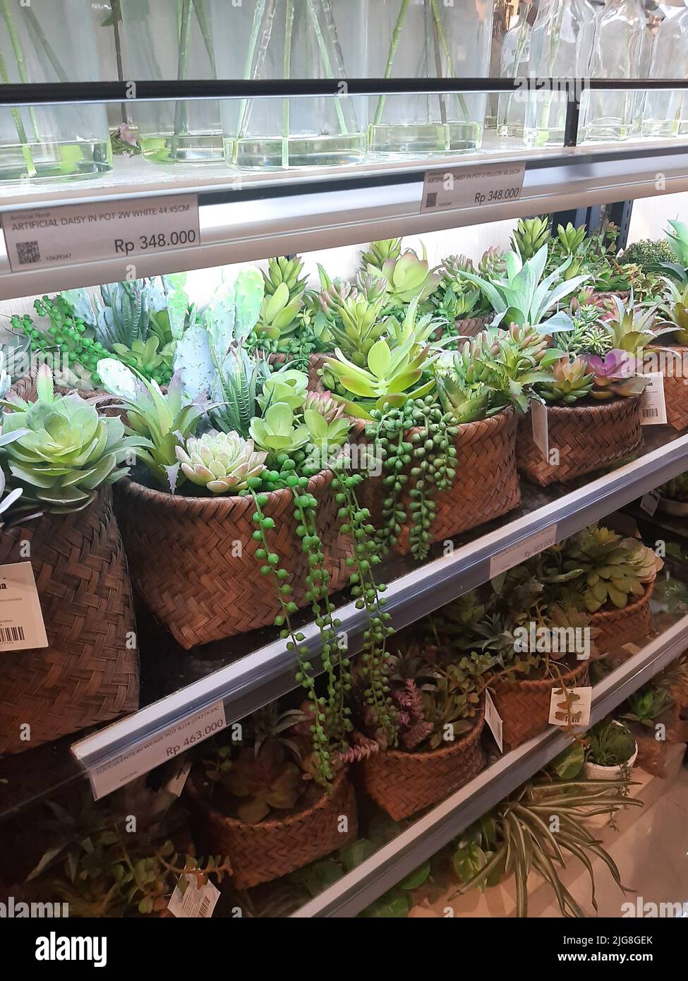 A vertical shot of unique flower displays with pots resembling ...