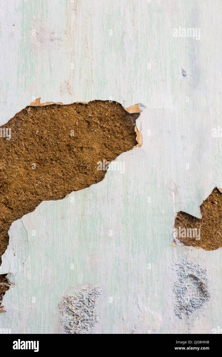 old weathered and damaged clay wall and plaster fragment, closeup ...