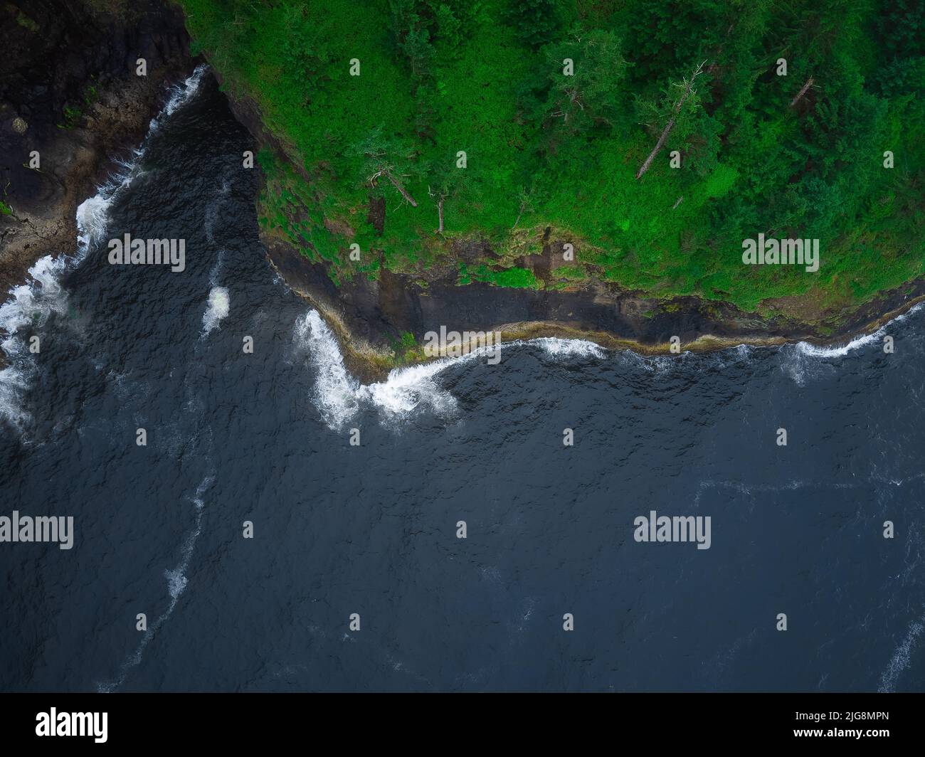 Drone shot. Green hilly coast and dark blue ocean water. Calm, calm ...