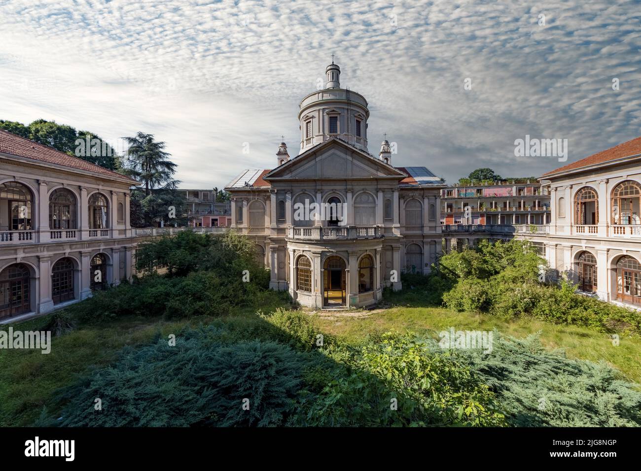 A view of a hospital chapel with a beautiful green-covered courtyard ...
