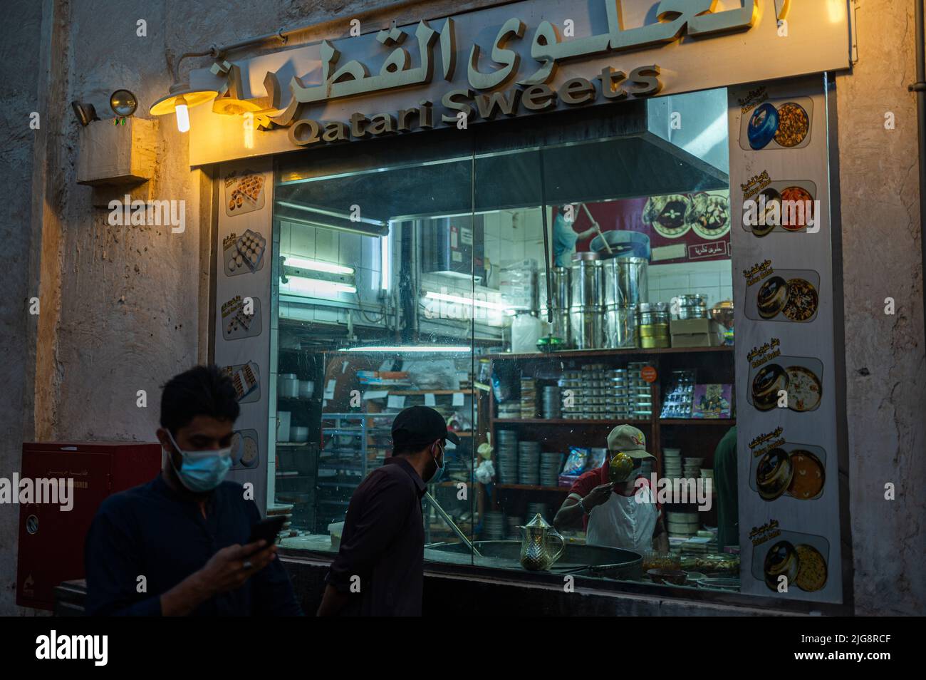 Doha, Qatar. 08th July, 2022. An employee of a candy store pours liquid ...