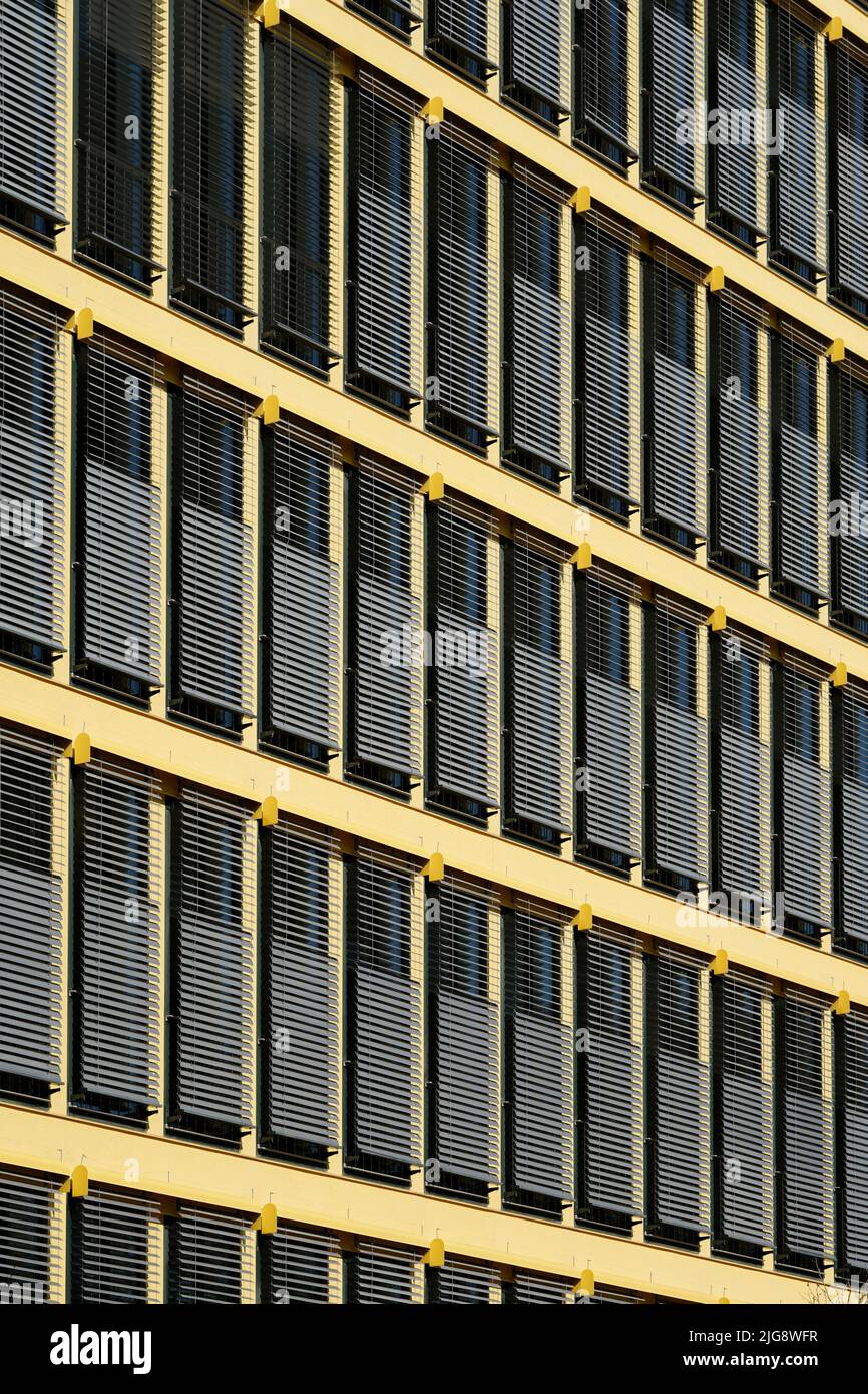 Germany, Bavaria, Munich, office building, yellow facade, sun blinds ...
