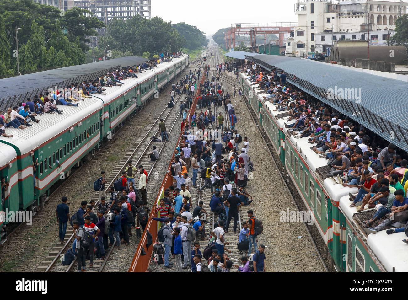 Dhaka, Bangladesh. 8th July 2022. Bangladeshi Muslim people sit on the roof of an overcrowded ...