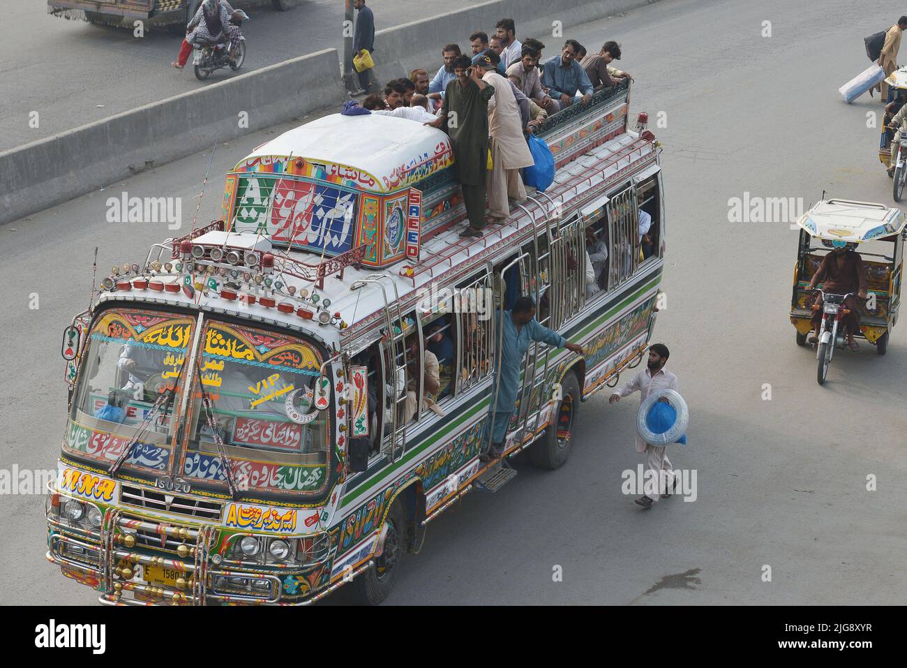 Pakistani people boarding roof top on a crowded bus as they travel to ...