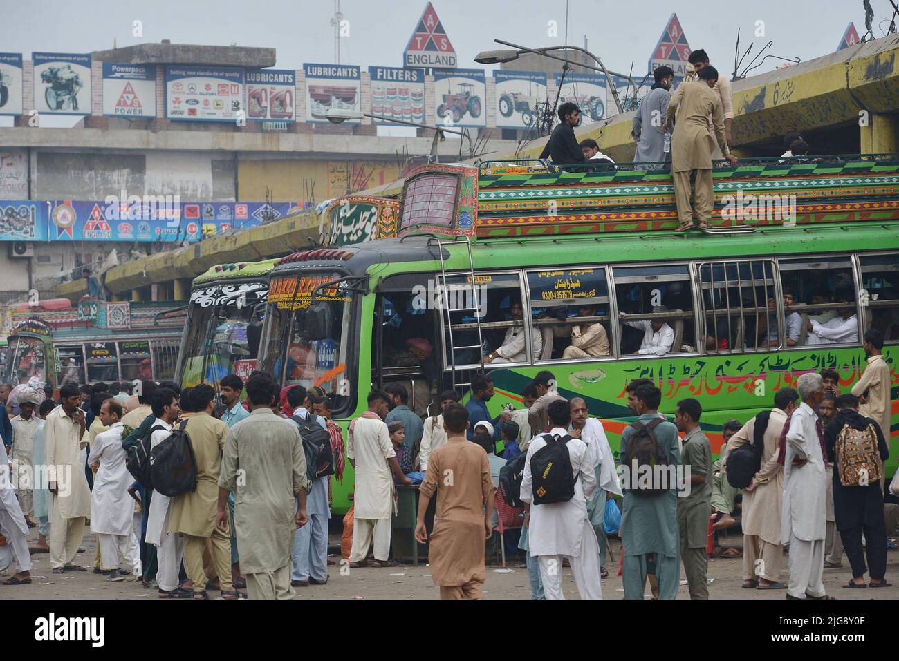 Pakistani people boarding roof top on a crowded bus as they travel to ...