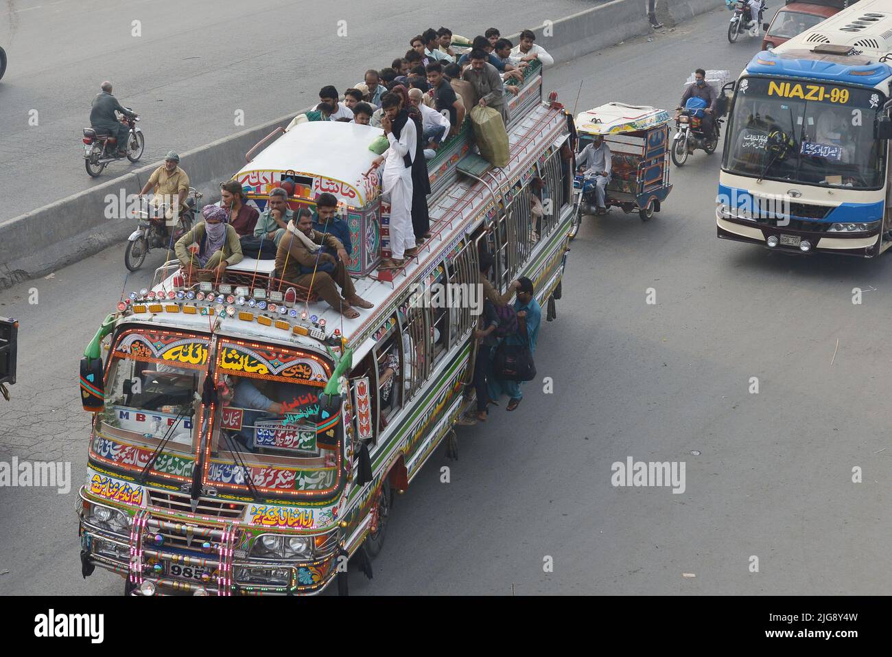 Pakistani people boarding roof top on a crowded bus as they travel to ...