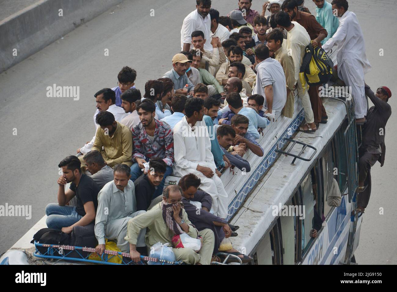 July 8, 2022, Lahore, Punjab, Pakistan: Pakistani people boarding roof ...
