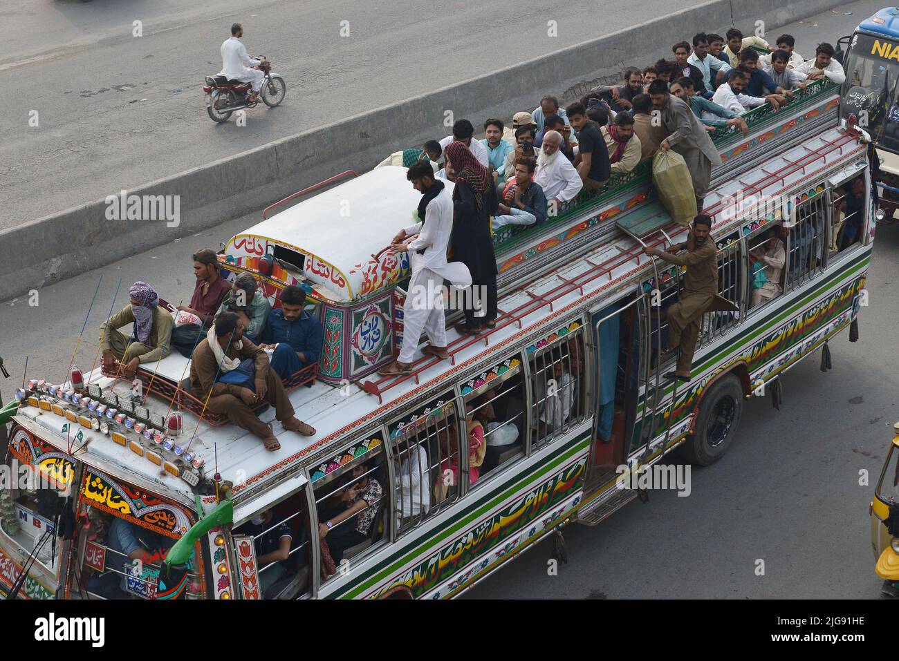 July 8, 2022, Lahore, Punjab, Pakistan: Pakistani people boarding roof ...